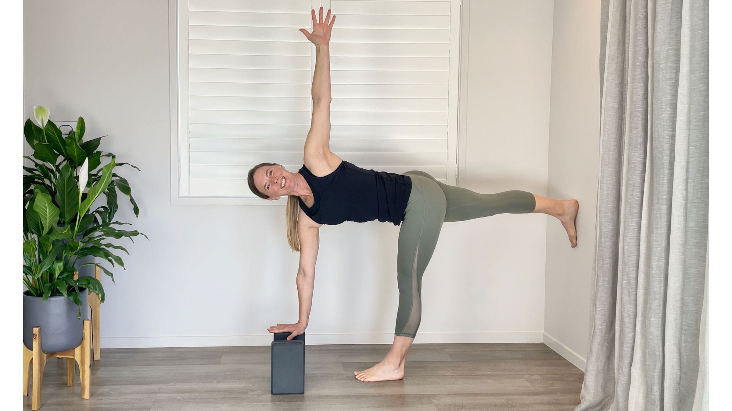 How a Wall Can Help You Practice Revolved Half Moon Pose