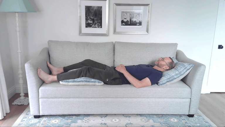 A Quick Couch Yoga Practice (Yes, Couch) So You Can Stay Sitting